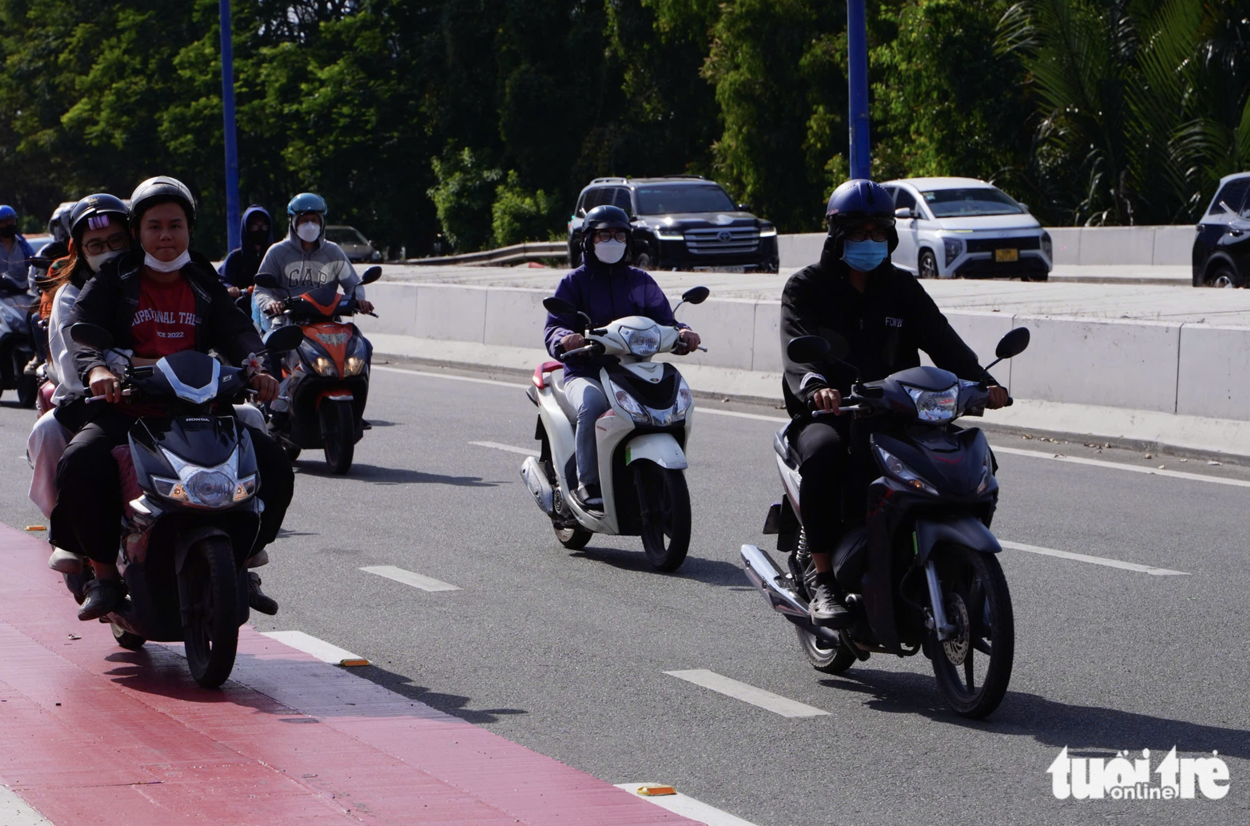 Motorbikes encroach on bicycle lane along Mai Chi Tho Boulevard in Ho ...