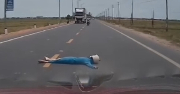 Vietnam police investigate viral clip of woman lying on road to block car